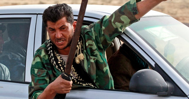 Qaddafi troops assault rebel city; dozens dead - CBS News