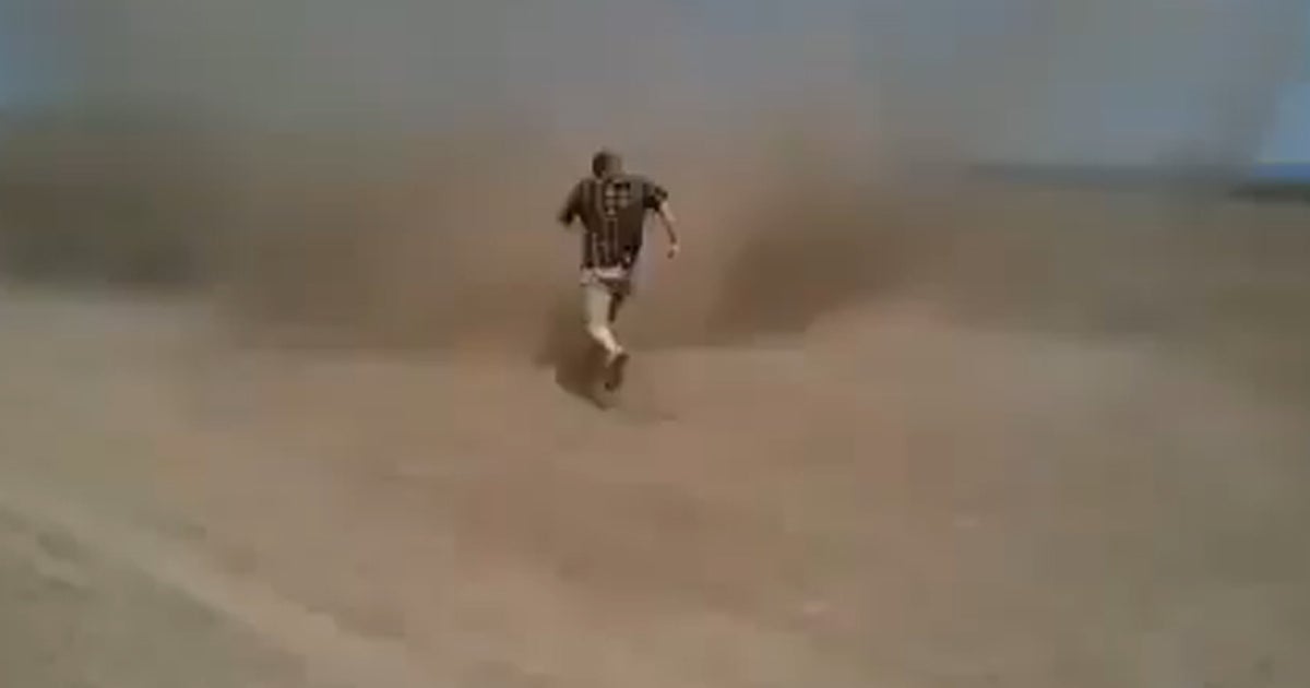 Guys play game of "chicken" with a dust devil (miniature tornado) - CBS ...