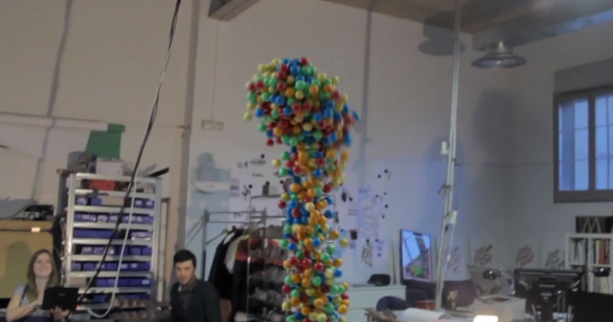 Electromagnet causes a cascade of colored balls - CBS News