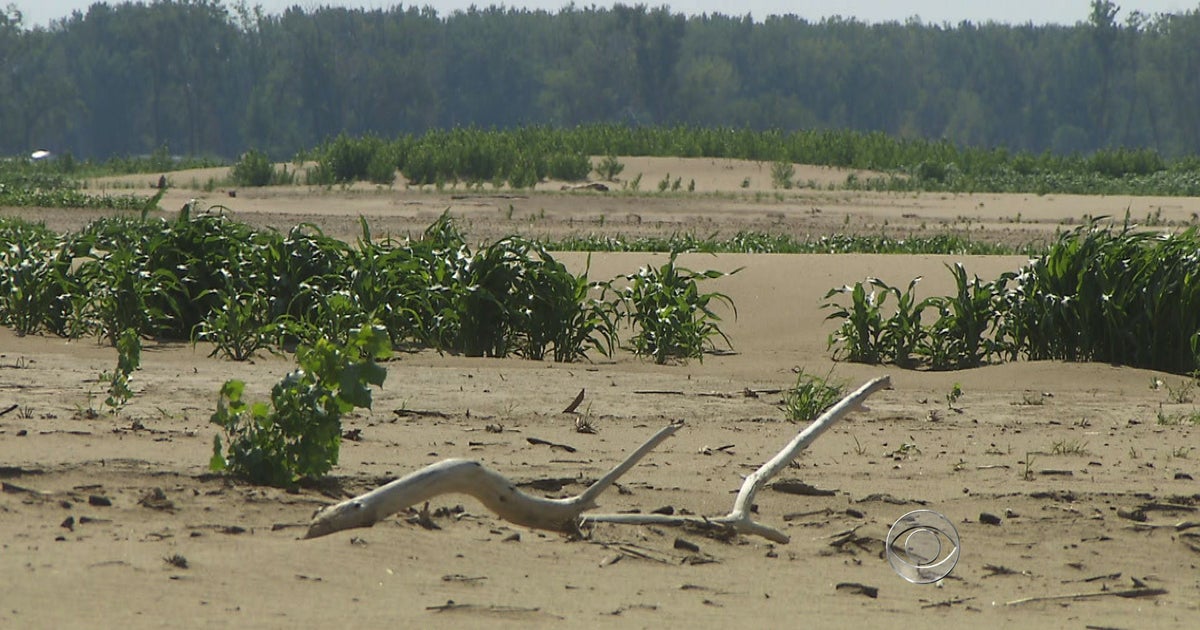 Amid drought, mountains of sand from last year's flood - CBS News