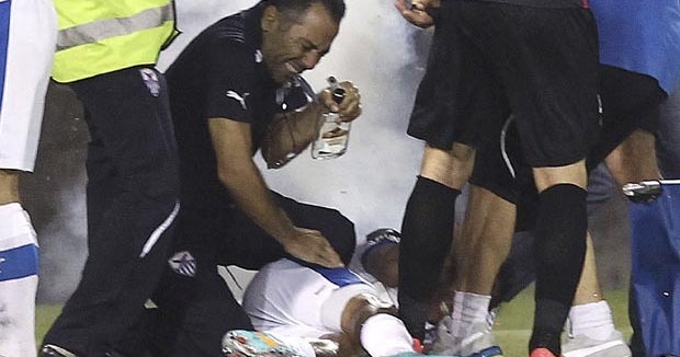 Watch: Soccer fans in Cyprus throw explosive at injured player - CBS News