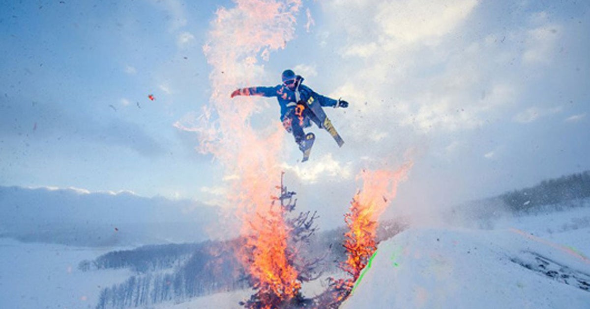 Fire and ice: Snow jumping over flaming trees - CBS News