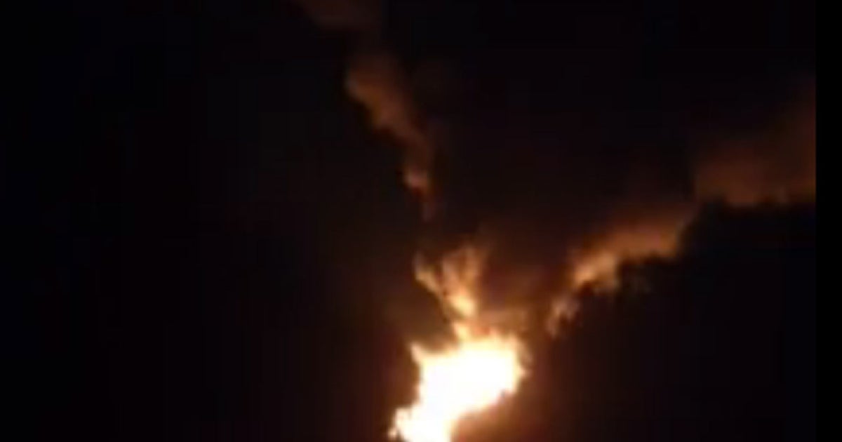 Train carrying crude oil derails, catches fire in Ala. - CBS News