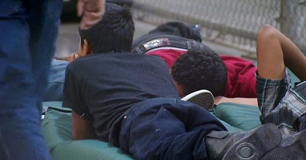 Officials struggle to house children flocking across border - CBS News