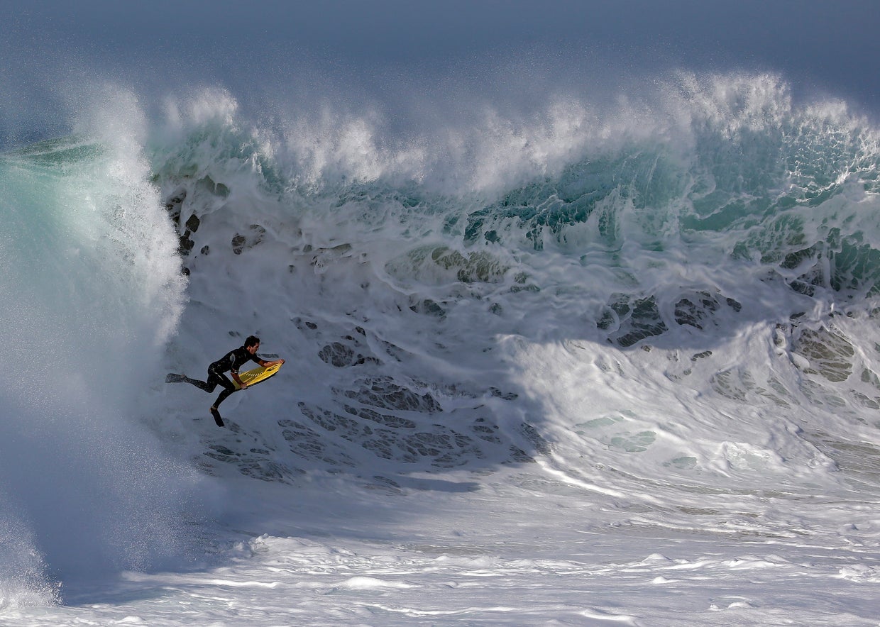 Surfers delight in Hurricane Marie's big waves