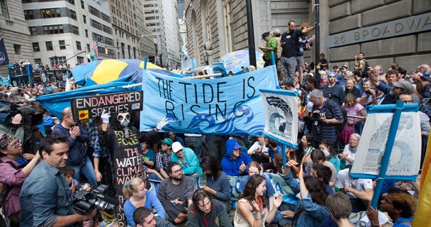 Climate change protesters march on Wall Street - CBS News