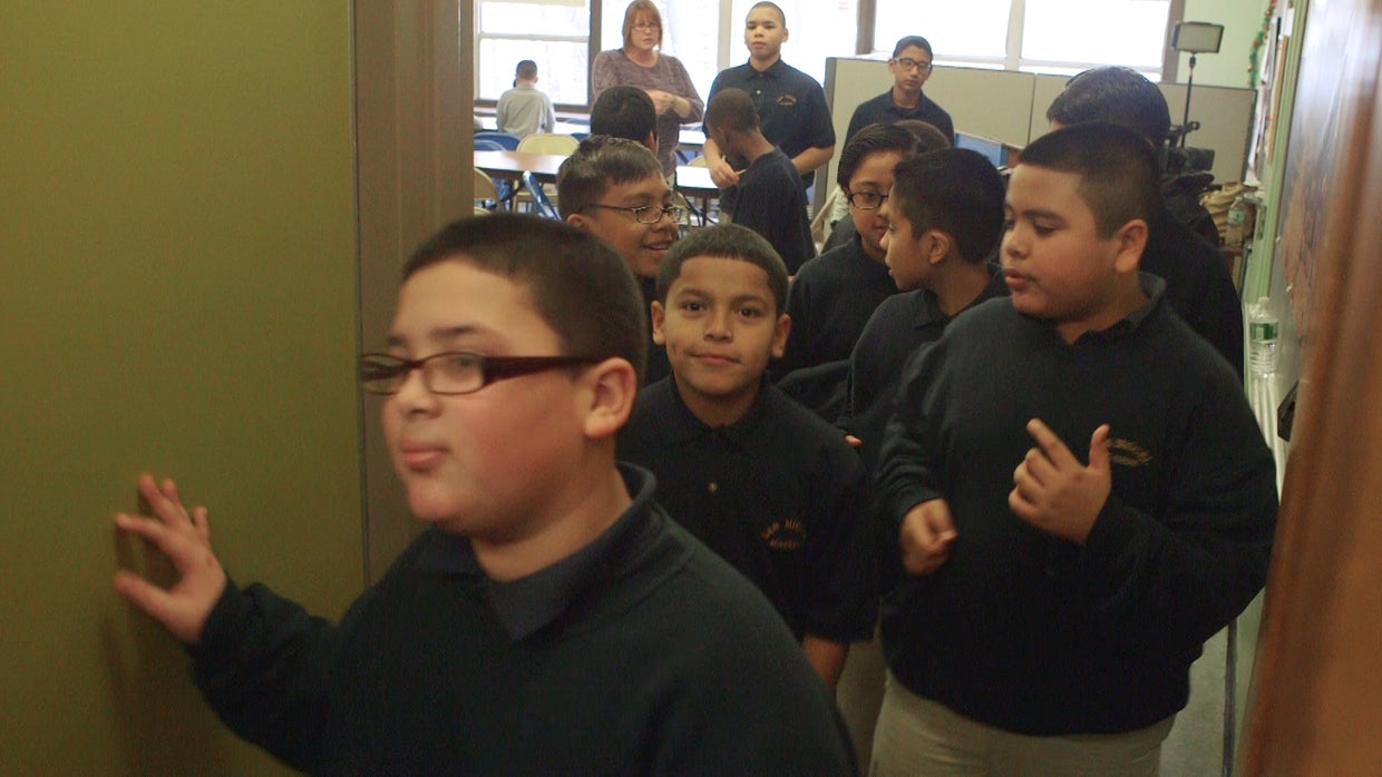 On crime-ridden streets, a priest and his school offer a way out - CBS News