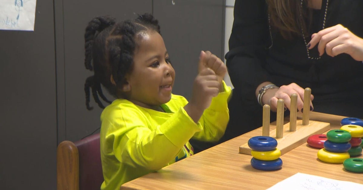 Deaf child hears mother's voice, does "happy dance" - CBS News