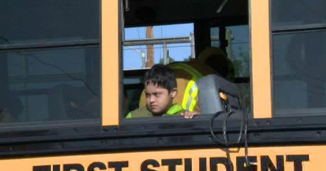 Railroad crossing arm crashes through school bus windows - CBS News