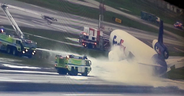 FedEx plane catches fire on runway in Florida - CBS News
