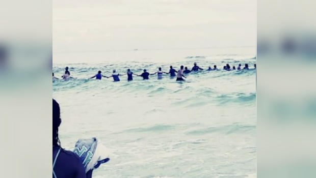 Dozens of strangers form human chain to rescue swimmers at Florida ...