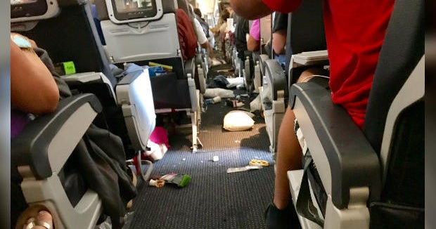 Images show aftermath of airliner hit by severe turbulence - CBS News