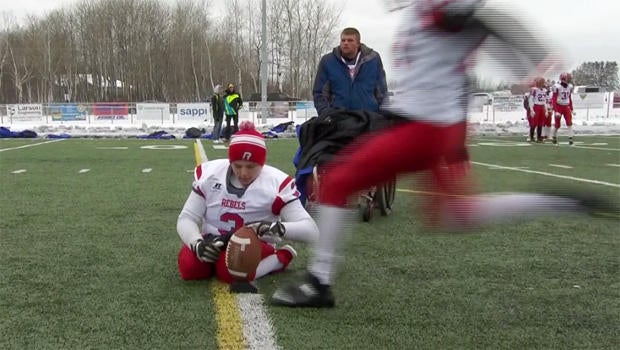 A wheelchair doesn't keep this athlete from the football field - CBS News