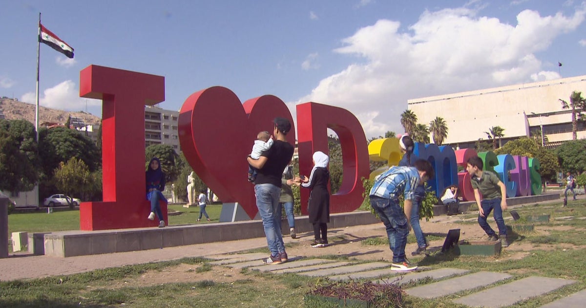 Just miles from alleged chemical attack, life goes on in Damascus - CBS ...