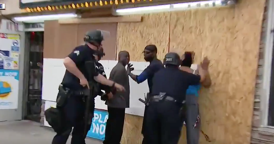 Police handcuff people trying to protect store from apparent looters ...