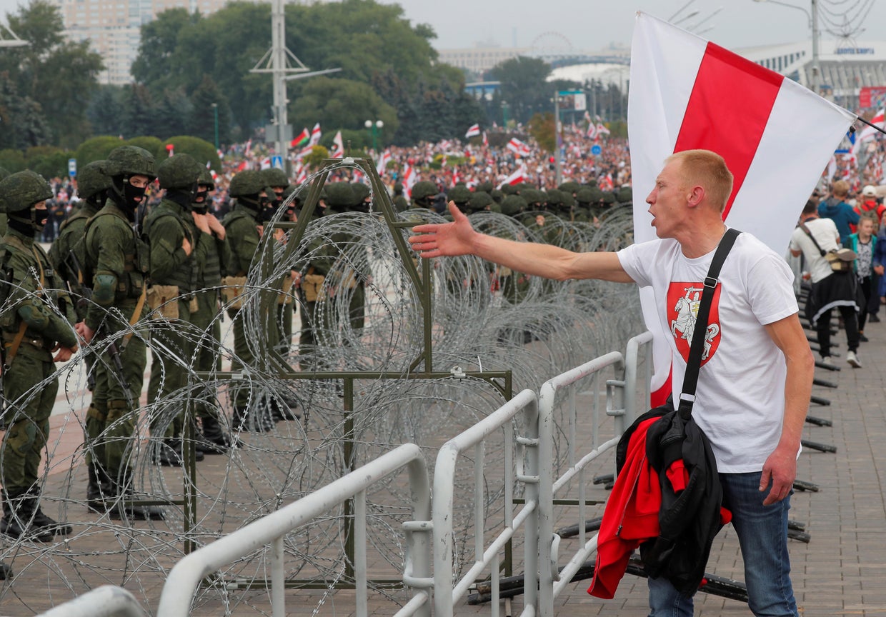Armed Belarus president remains defiant as protesters demand his ...