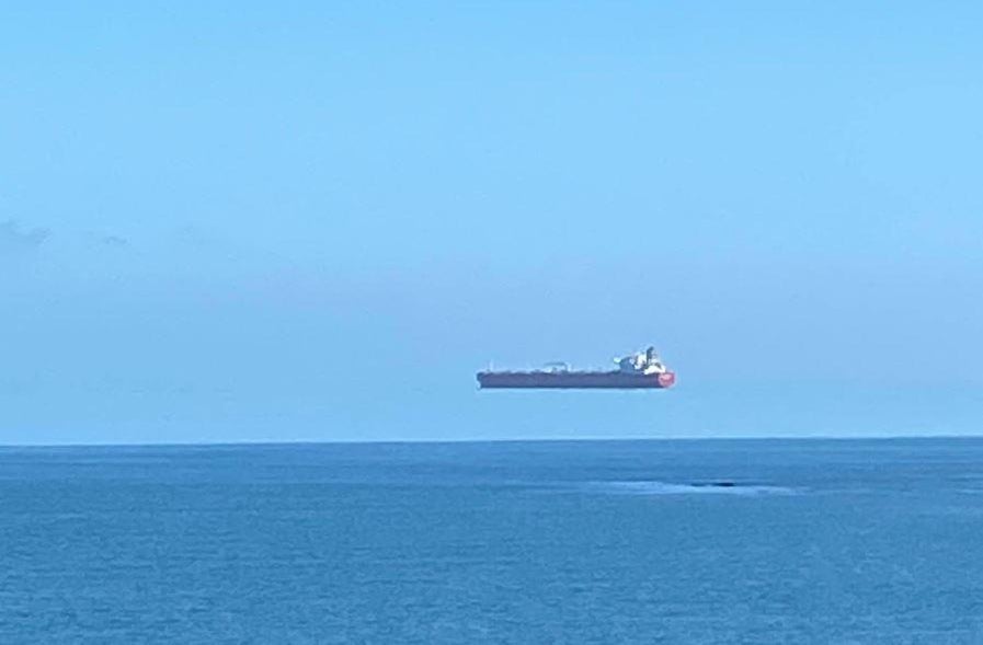 Photos appear to show a giant ship hovering over the water off the ...