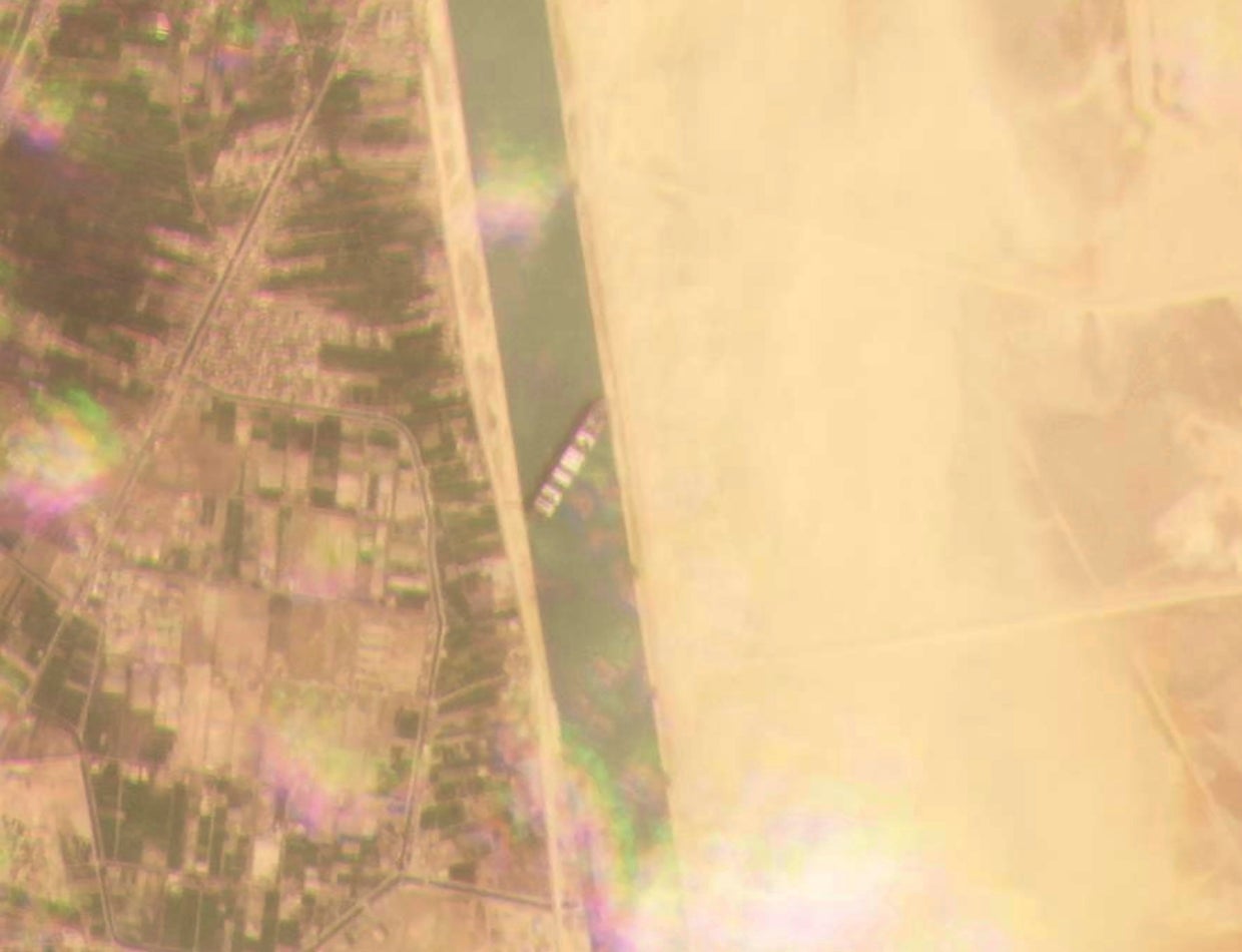 Massive cargo ship totally blocks Suez Canal after turning sideways ...