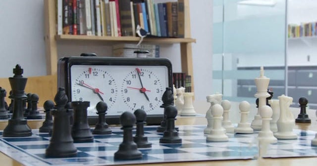 New York City students, police officers face off in chess - CBS News