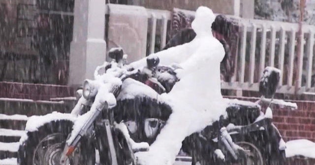 Snowman escaping winter on motorcycle? - CBS News