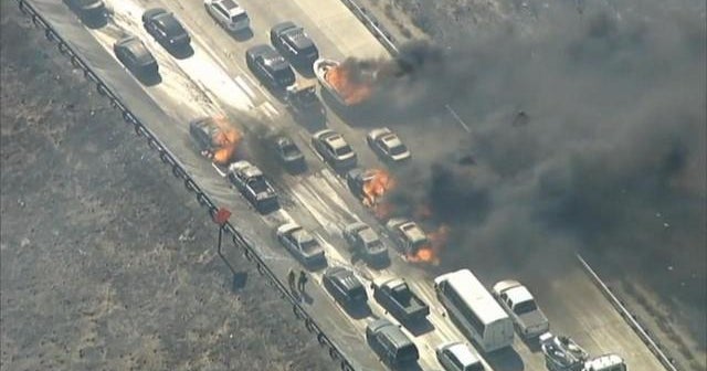 California wildfire torches several cars on major highway - CBS News