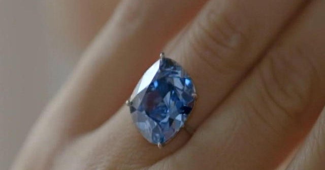 Rare "Blue Moon" diamond sells for record $48 million at auction - CBS News