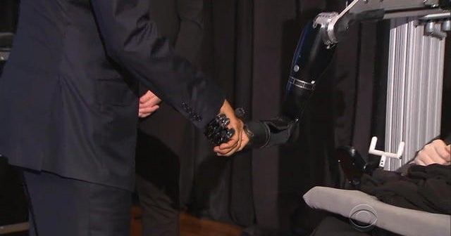 President shares monumental handshake with paralyzed man - CBS News