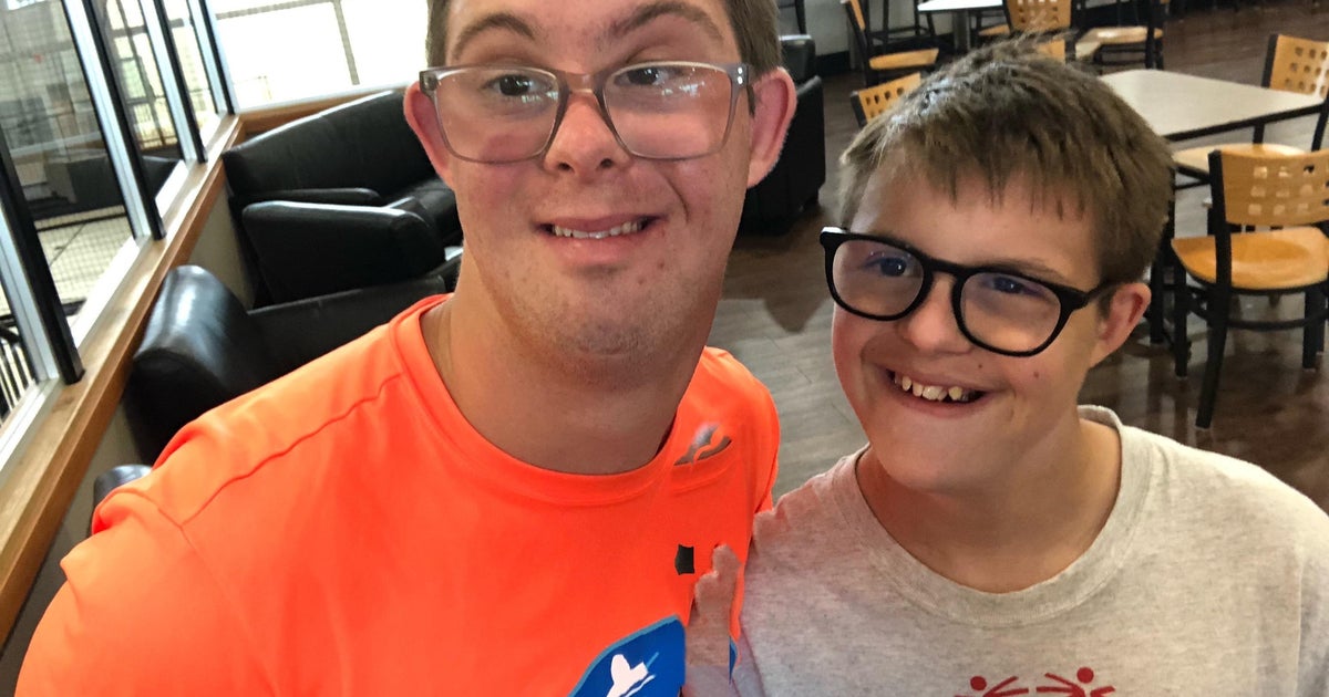 Role model inspires boy with Down Syndrome to complete mini-triathlon ...