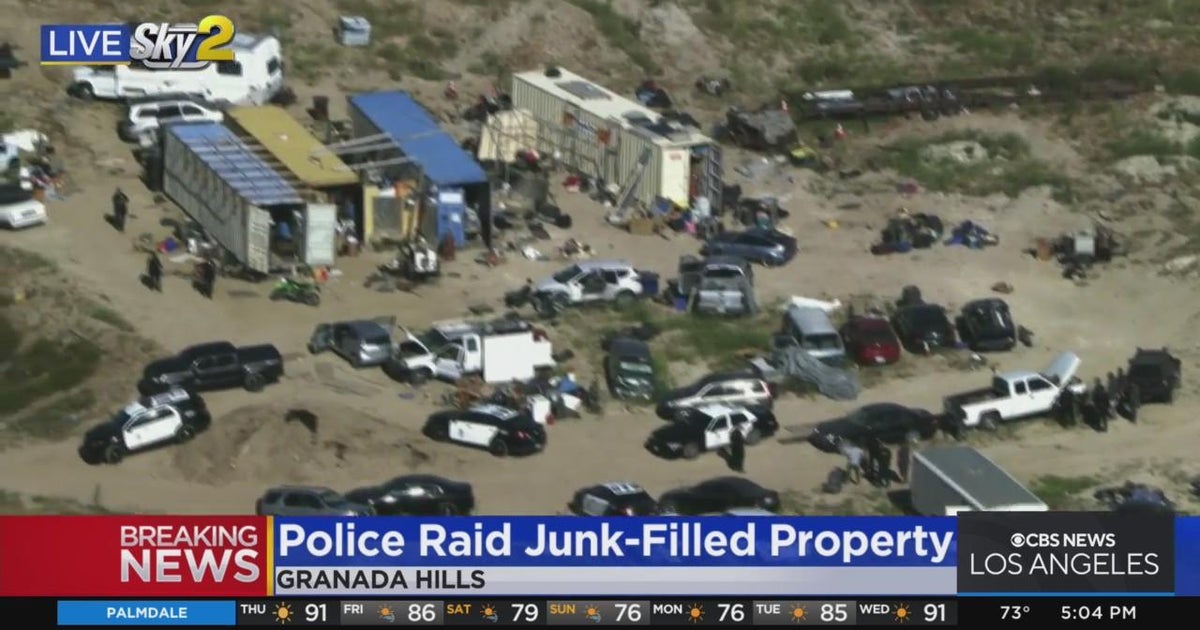 Police raid junk-filled property after viewer spots stolen van - CBS ...