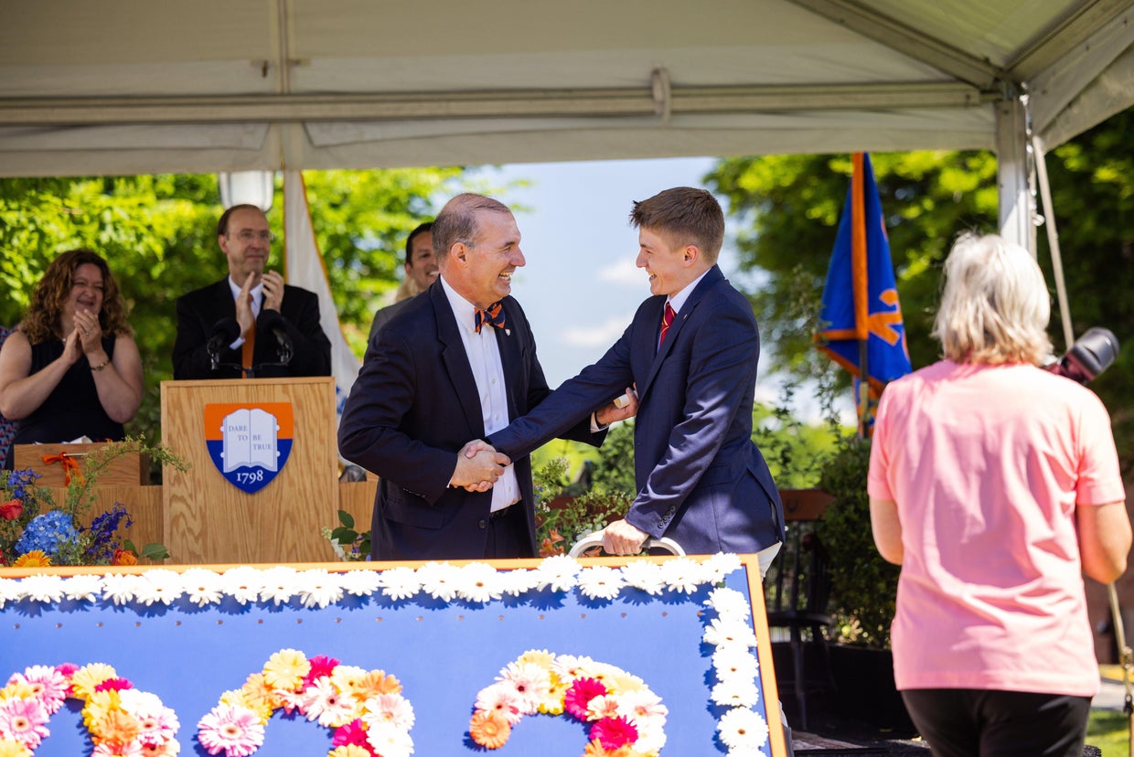 He was paralyzed in a hockey game, but vowed to walk across stage at ...