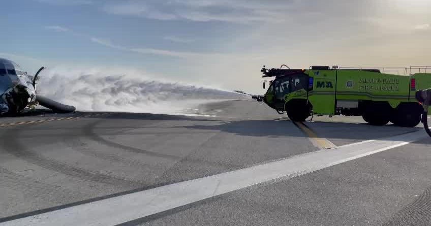 MDFR shooting foam at the damaged jetliner - CBS Miami