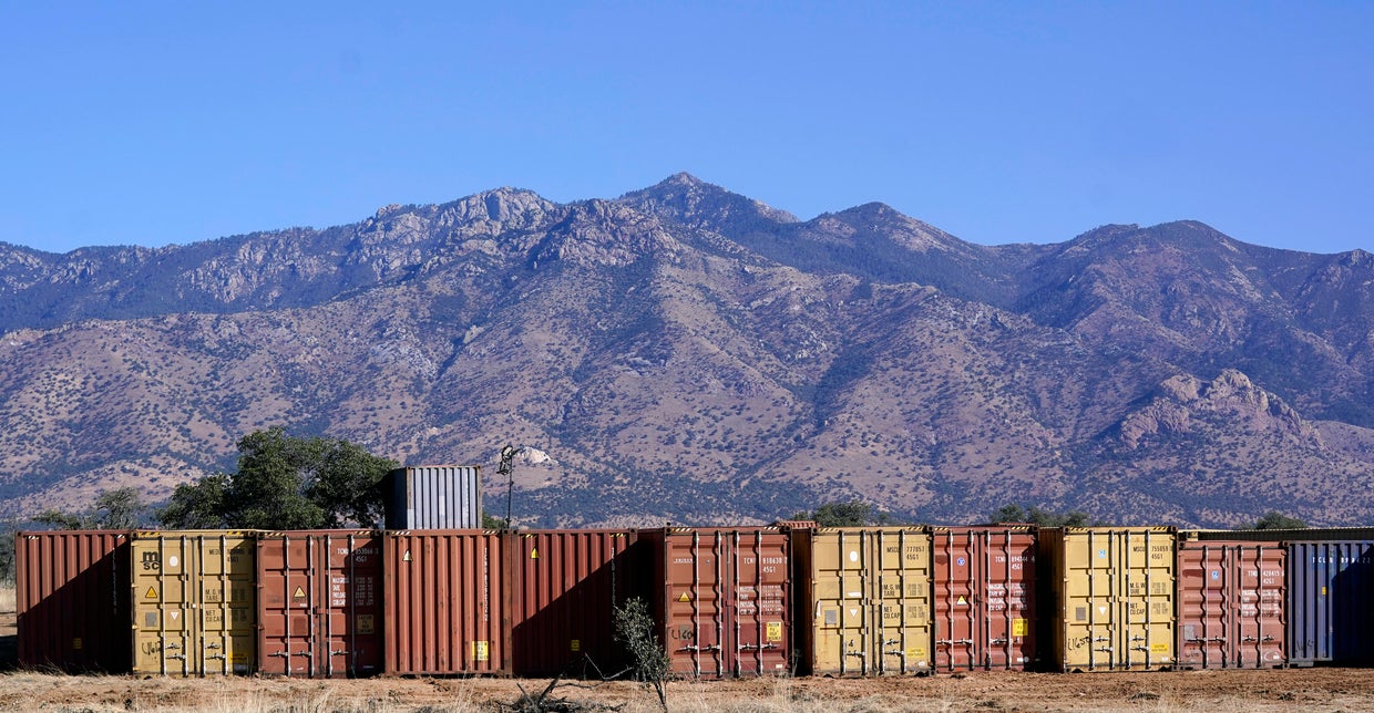 Arizona Gov. Doug Ducey, preparing to leave office, stacks containers ...