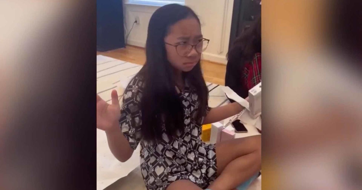 Daughter gives "best reaction" to gifts - CBS News