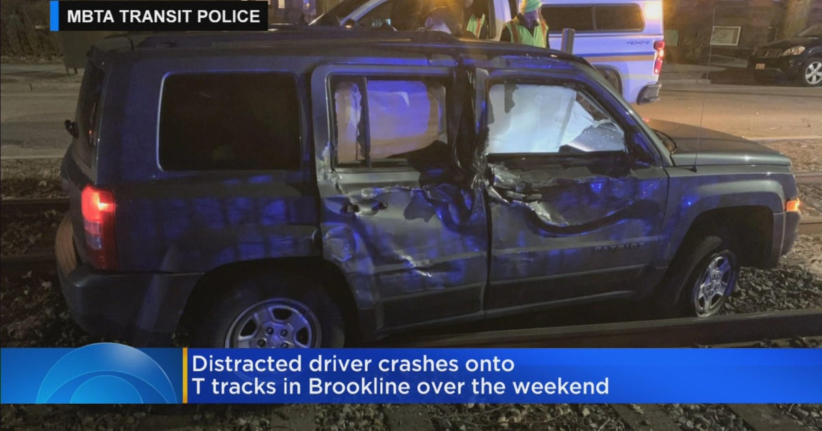Distracted driver crashes onto T tracks, police say - CBS Boston