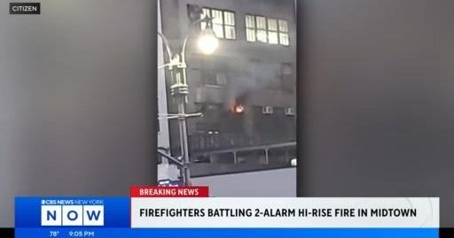 Firefighters battling 2-alarm high-rise fire in Midtown - CBS New York