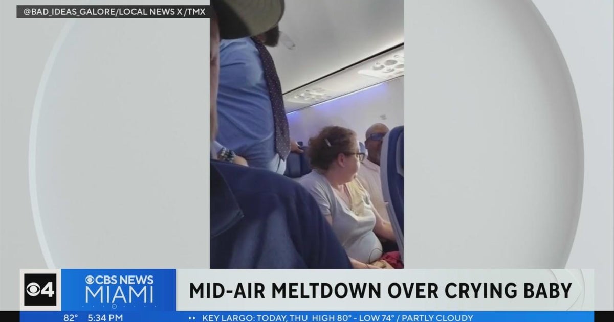 Man has mid air meltdown over crying baby - CBS Miami