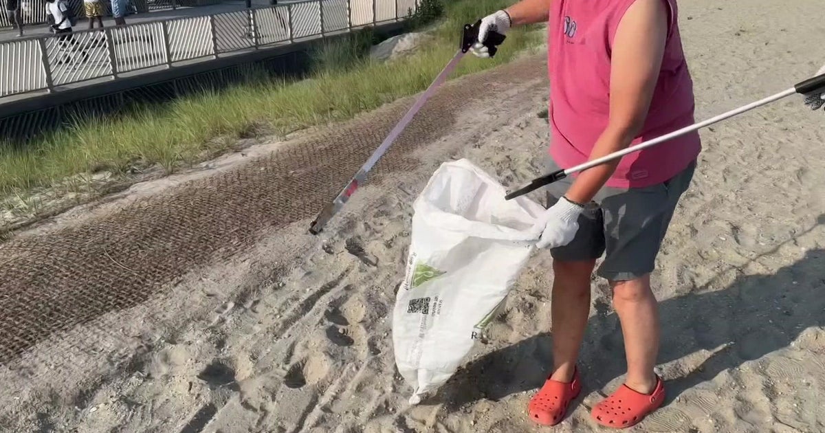 Volunteers at Rockaway Beach clean up mess left behind from July 4th ...