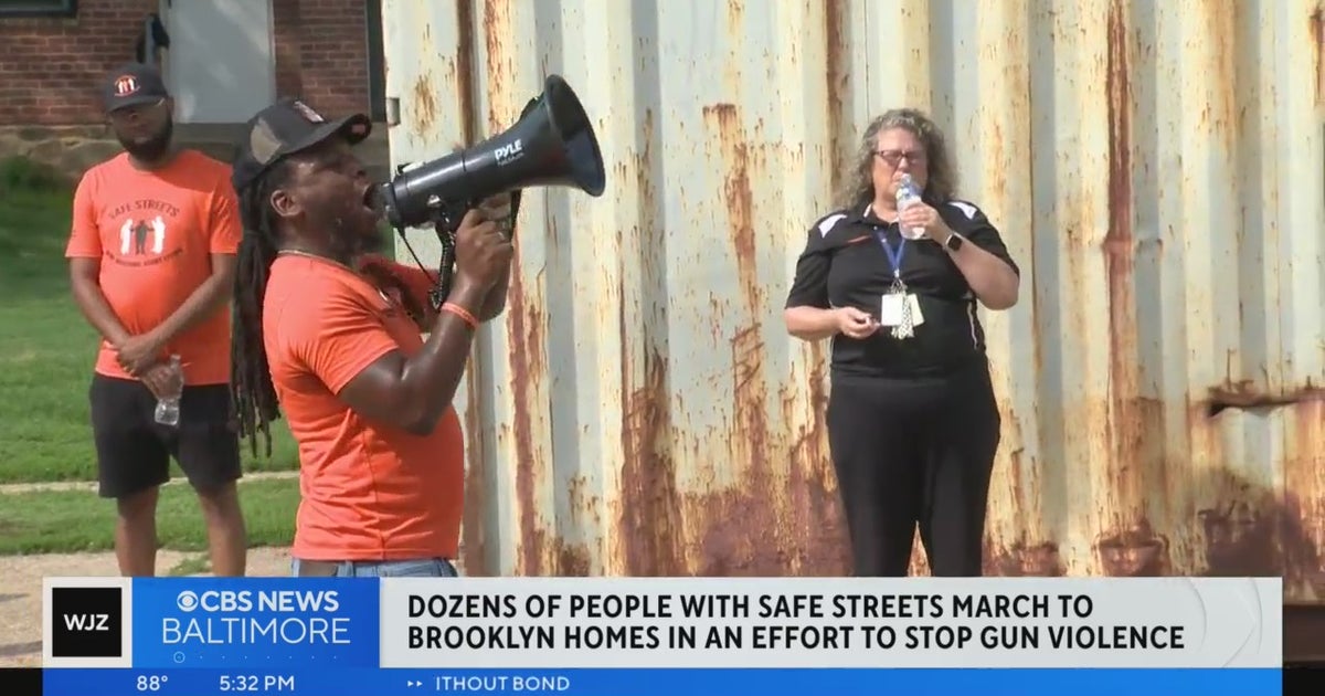 Community members march in South Baltimore following a mass shooting ...