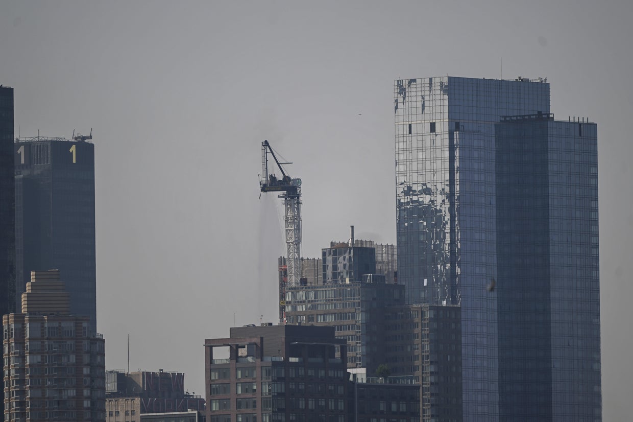 Photos: Crane catches fire, partially collapses in NYC