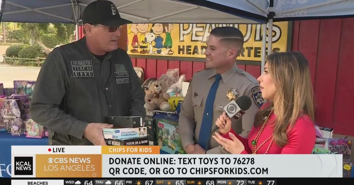 Officer Mitch Smith is with Alex Biston collecting toys at Knott’s ...