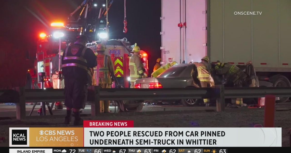 2 rescued after car gets pinned underneath a semi in Whittier - CBS Los ...