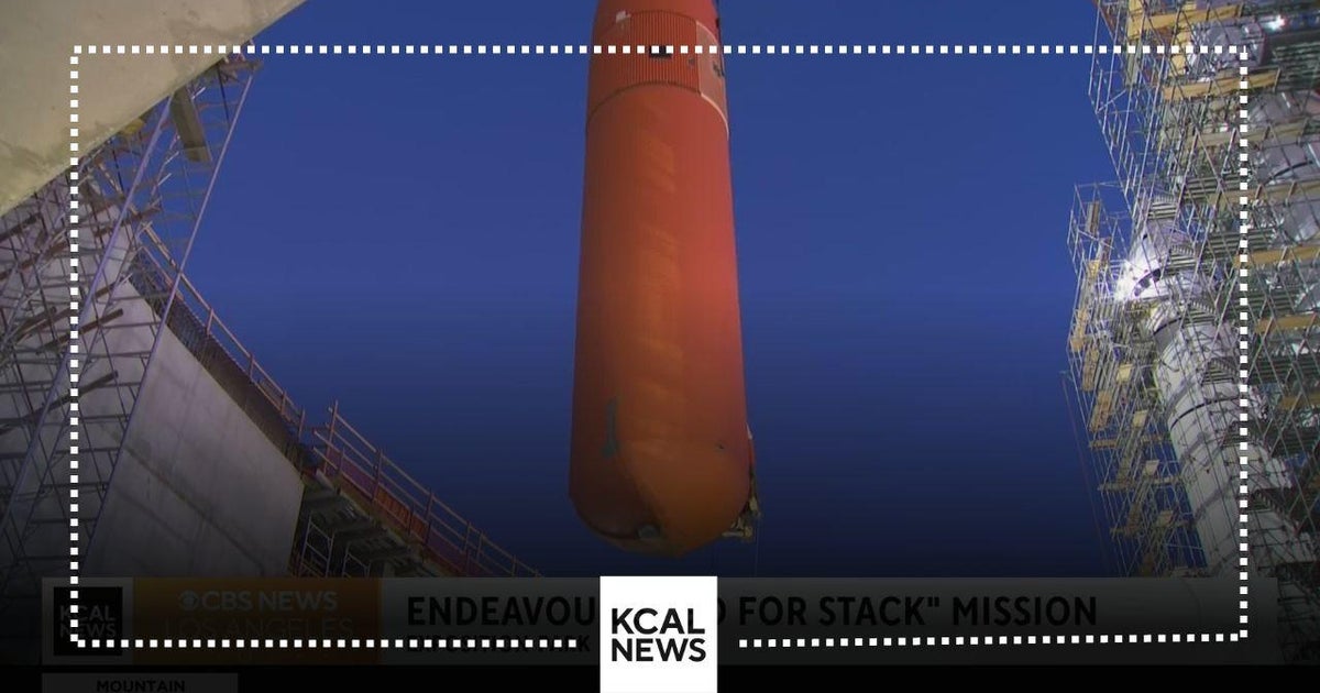 The massive external space shuttle tank moves into the Endeavour's ...