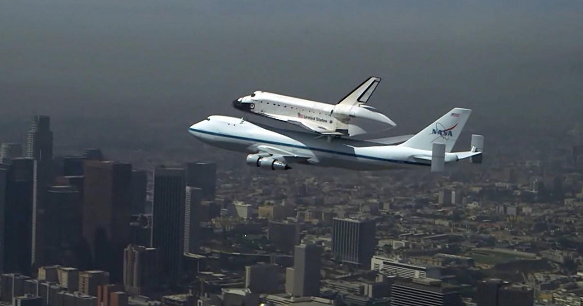 Retired space shuttle set to be raised by cranes for display - CBS News