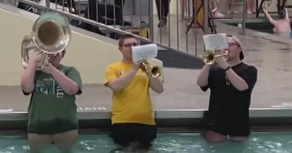 Hutchinson High School band plays in the pool for boys swim meet - CBS ...