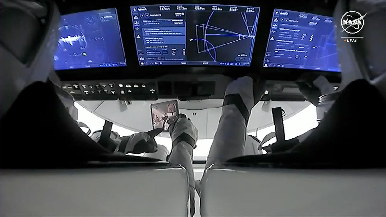 Crew Dragon docks with space station, bringing four fresh crew members ...