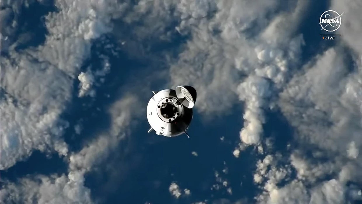 Crew Dragon docks with space station, bringing four fresh crew members ...