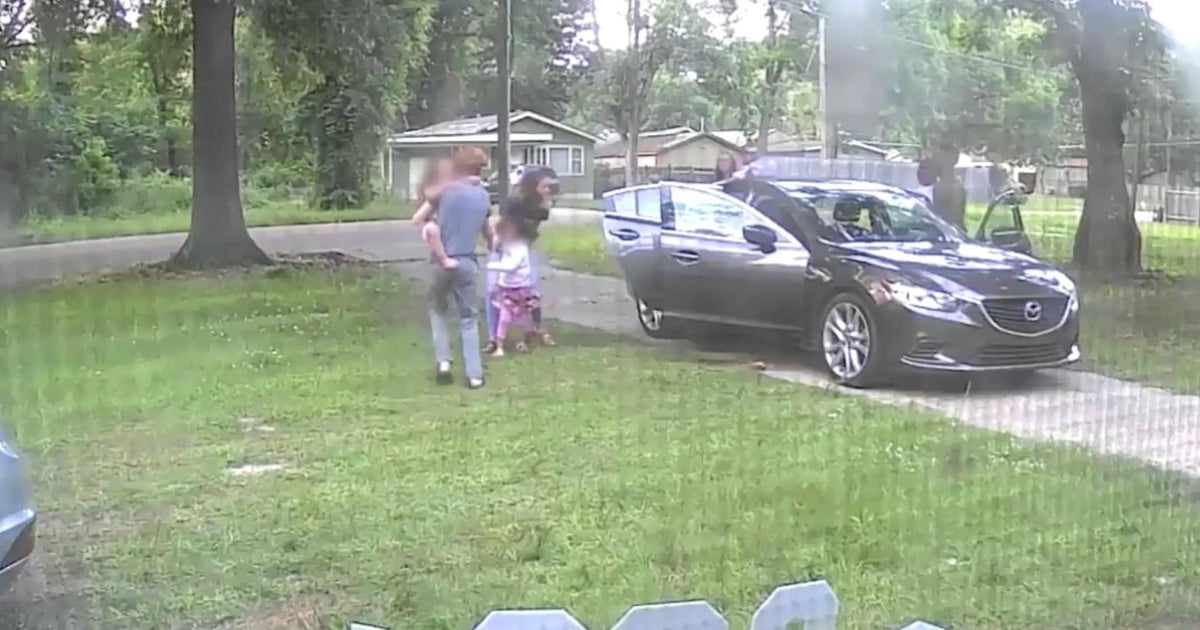 Video shows family being carjacked in their own driveway with children ...