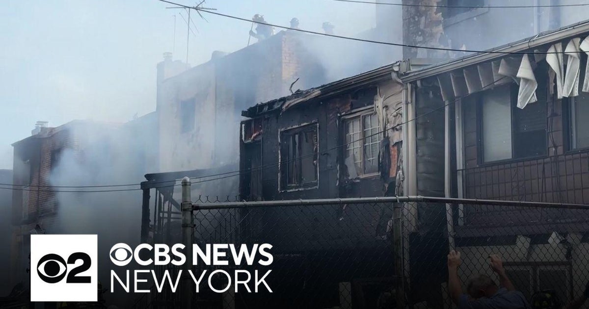 14 injured as 5-alarm fire rips through Queens homes - CBS New York