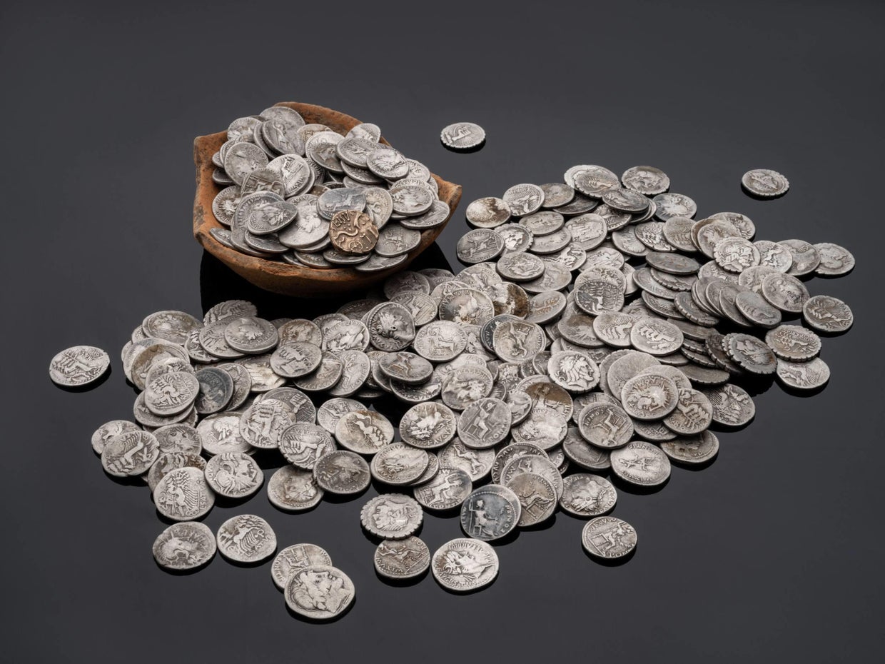 Treasure trove of Roman coins found during construction in U.K. - CBS News