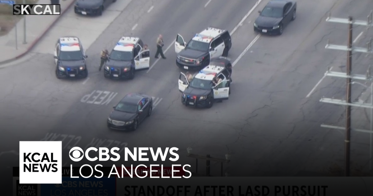 Possibly armed man barricades inside car after lengthy pursuit with ...